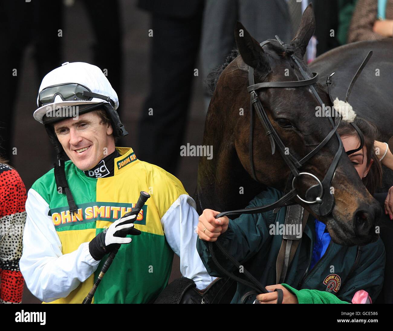 Anthony McCoy (left) celebrates winning the John Smith's Melling Chase ...