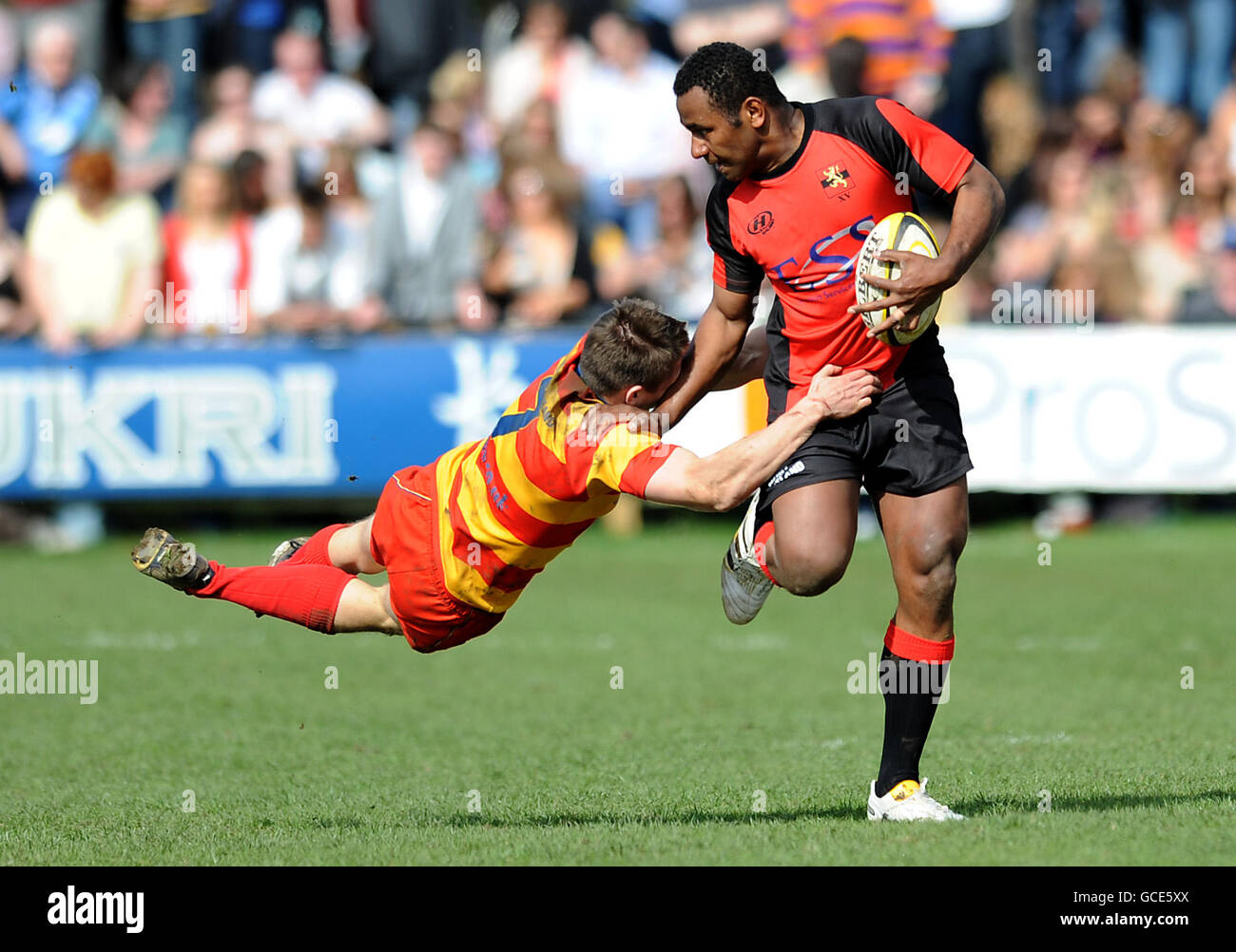 The Army In Scotland's Jim Naquarase is tackled by West of Scotland's ...
