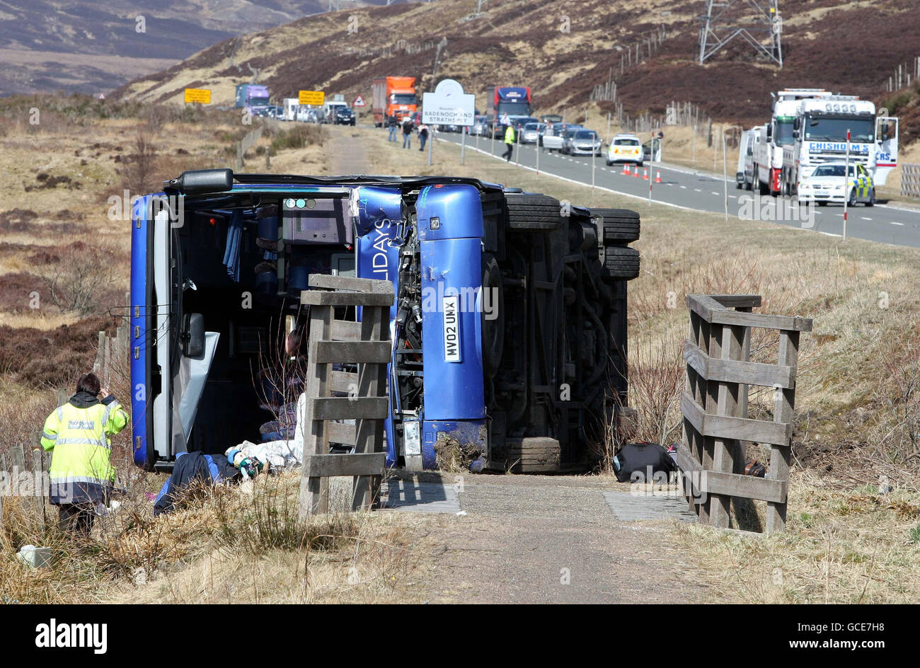Accident investigators view the overturned coach after it crashed near ...