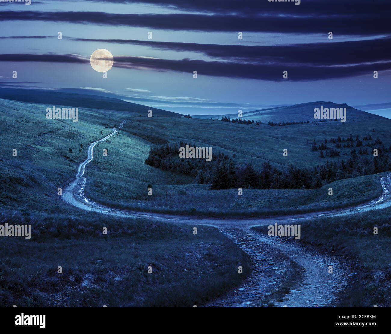 composite landscape. fence near the cross road on hillside meadow in ...