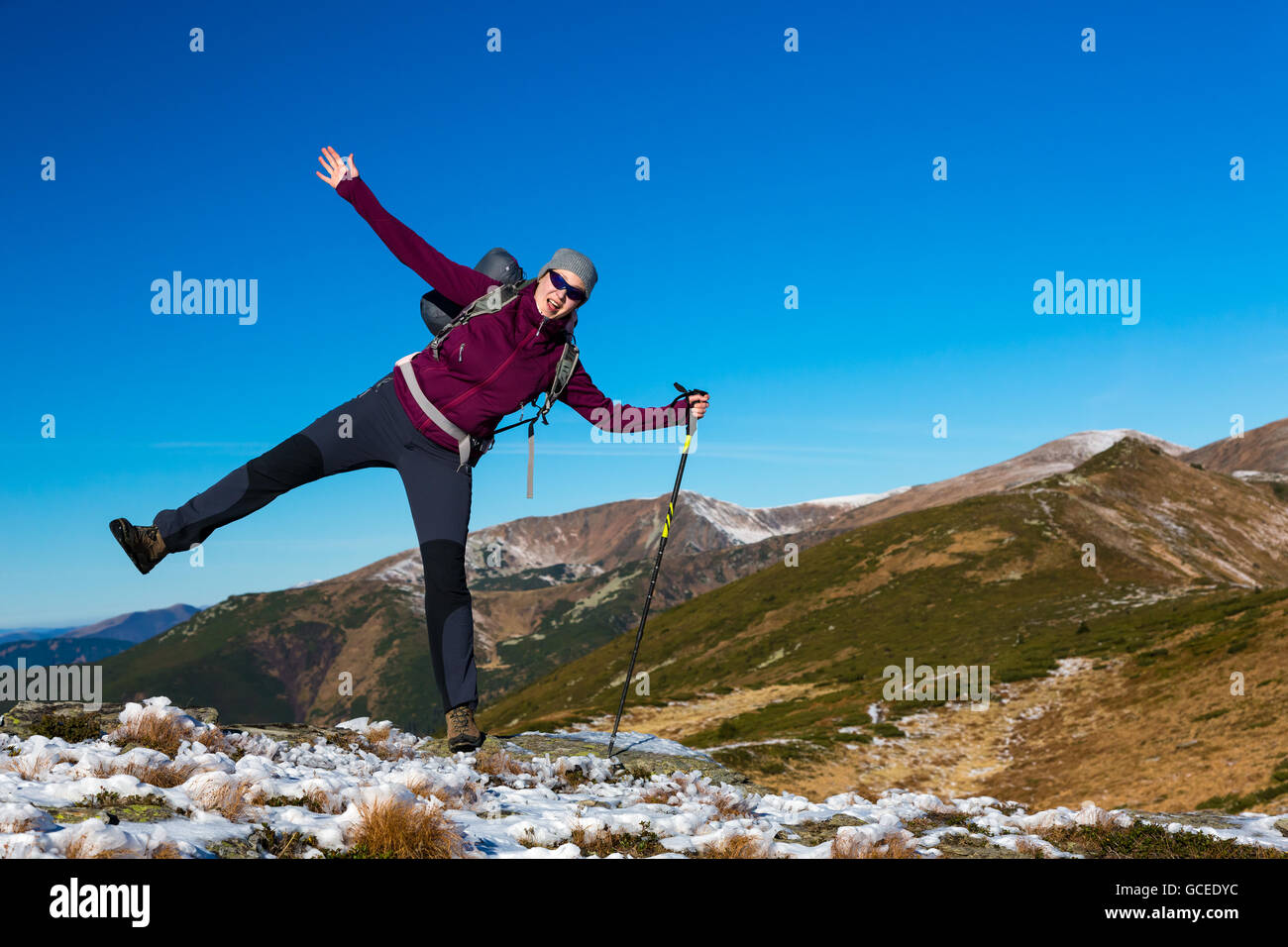 Female Hiker staying unstable on one leg falling on side in Mountains ...