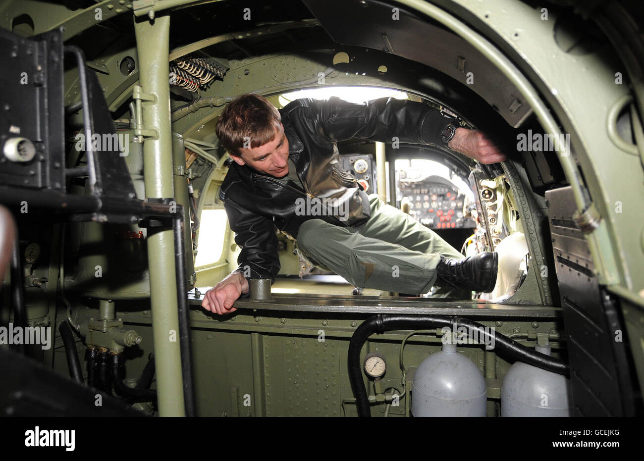 Pilot Flt Lt Ed Straw demonstrates the cramped working conditions faced ...