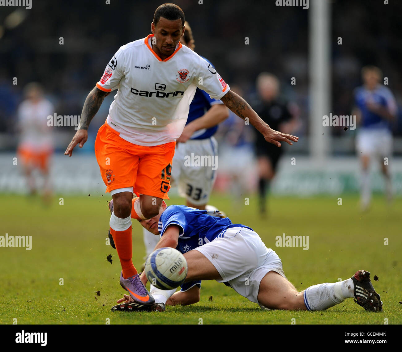 Peterborough United's Danny Andrew is beaten by Blackpool's DJ Campbell ...