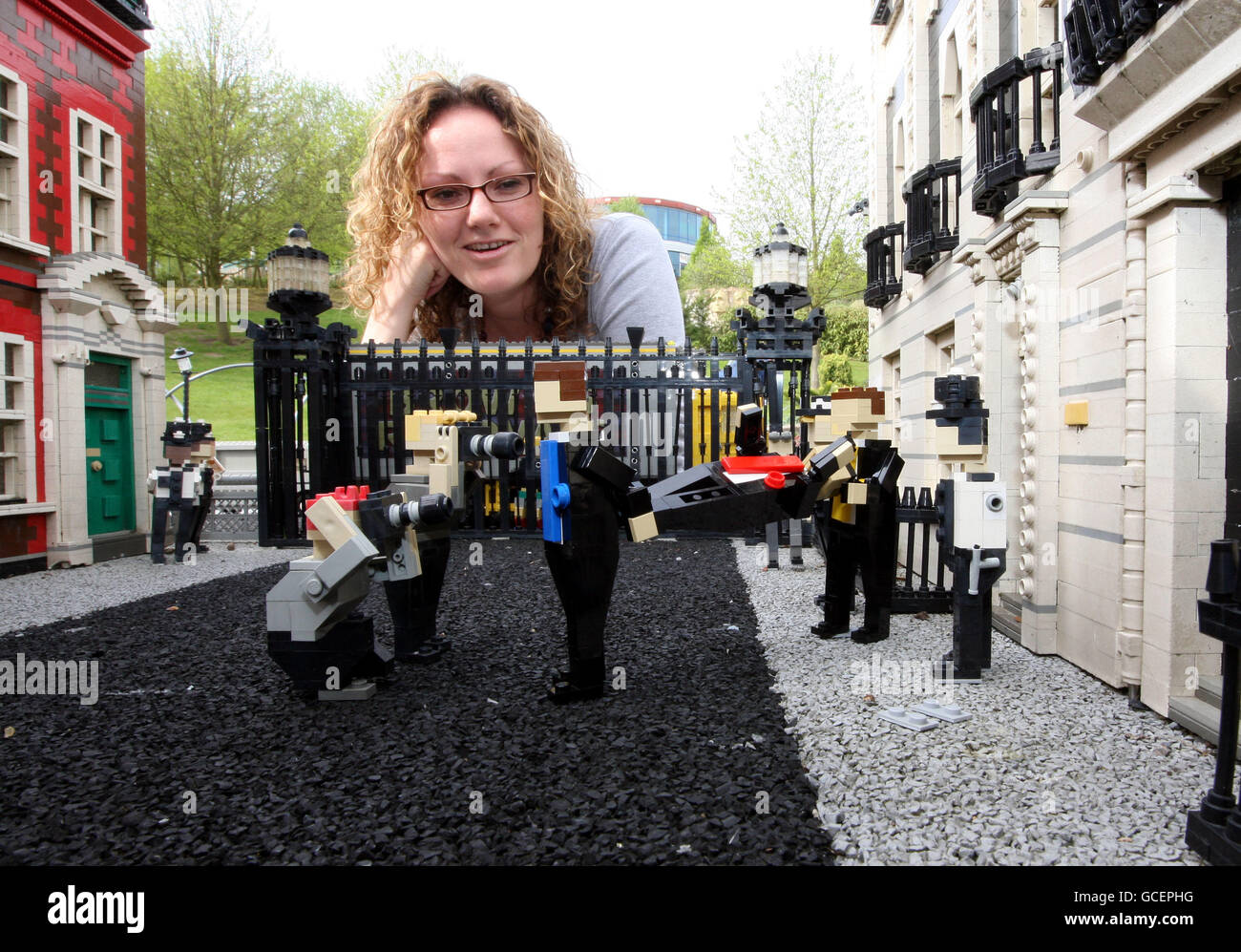 Legoland employee Rebecca Head looks at mini lego figures of Nick Clegg ...