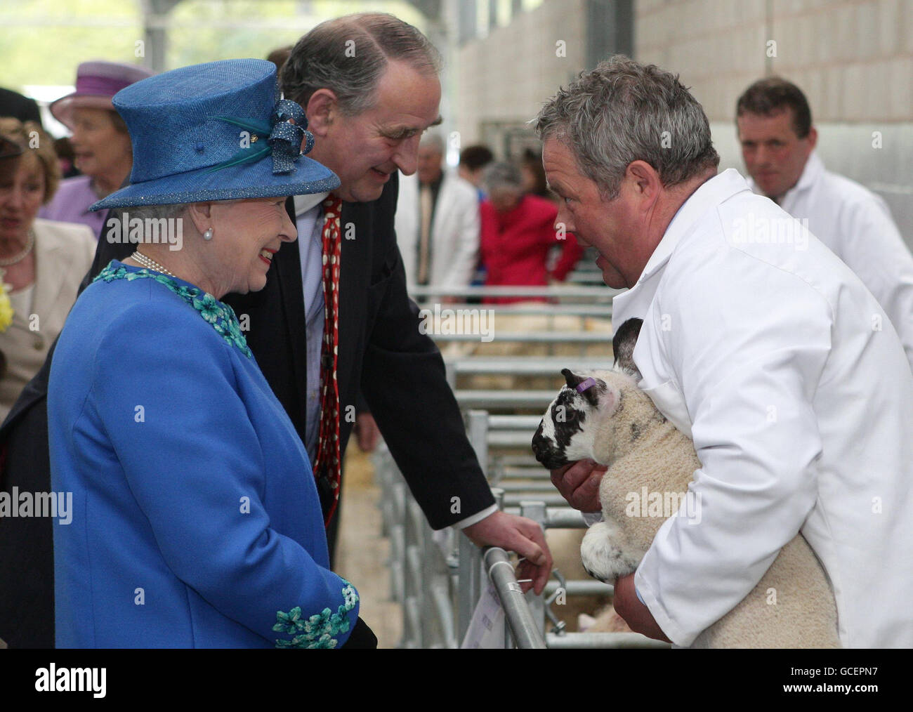 Queen Elizabeth II meets farmer Gwyn Price (right) and one of his lambs ...