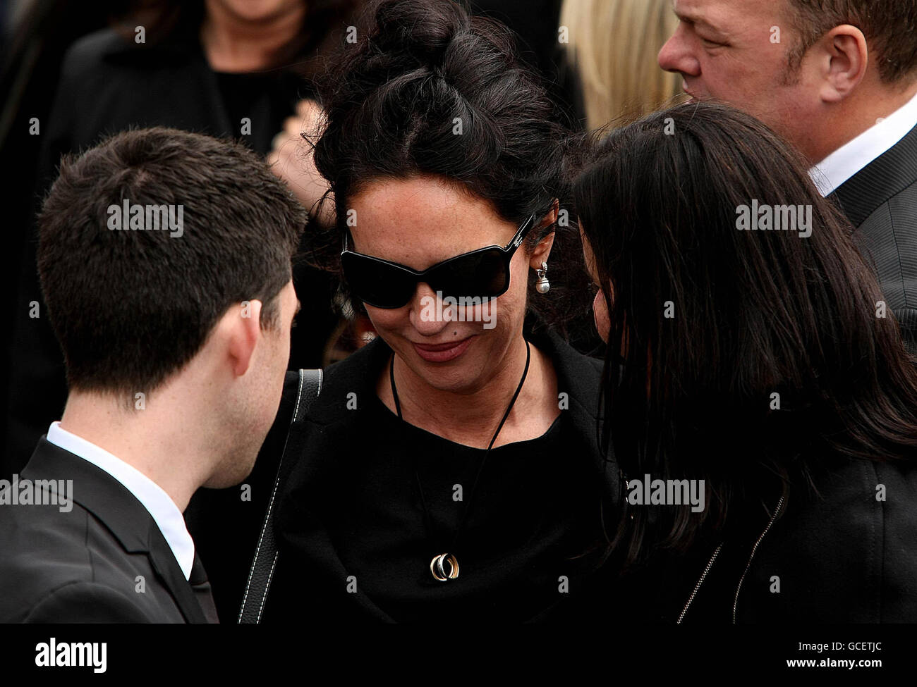Gerry Ryan's, wife Morah (centre) at the funeral service at St John the ...