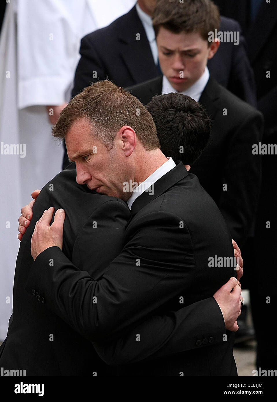 Gerry Ryan's brother, Mick (right), hugs, his nephew brother's son, Rex ...