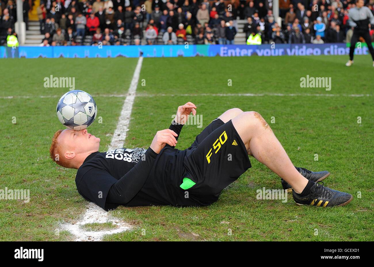 Football freestyler Dan Magness shows off his skills during half time ...