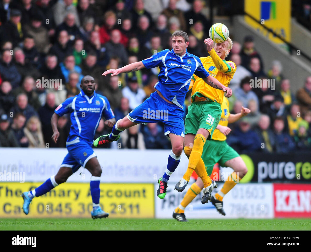 Norwich's Zak Whitbread (right) and Stockport's George Donnelly battle ...