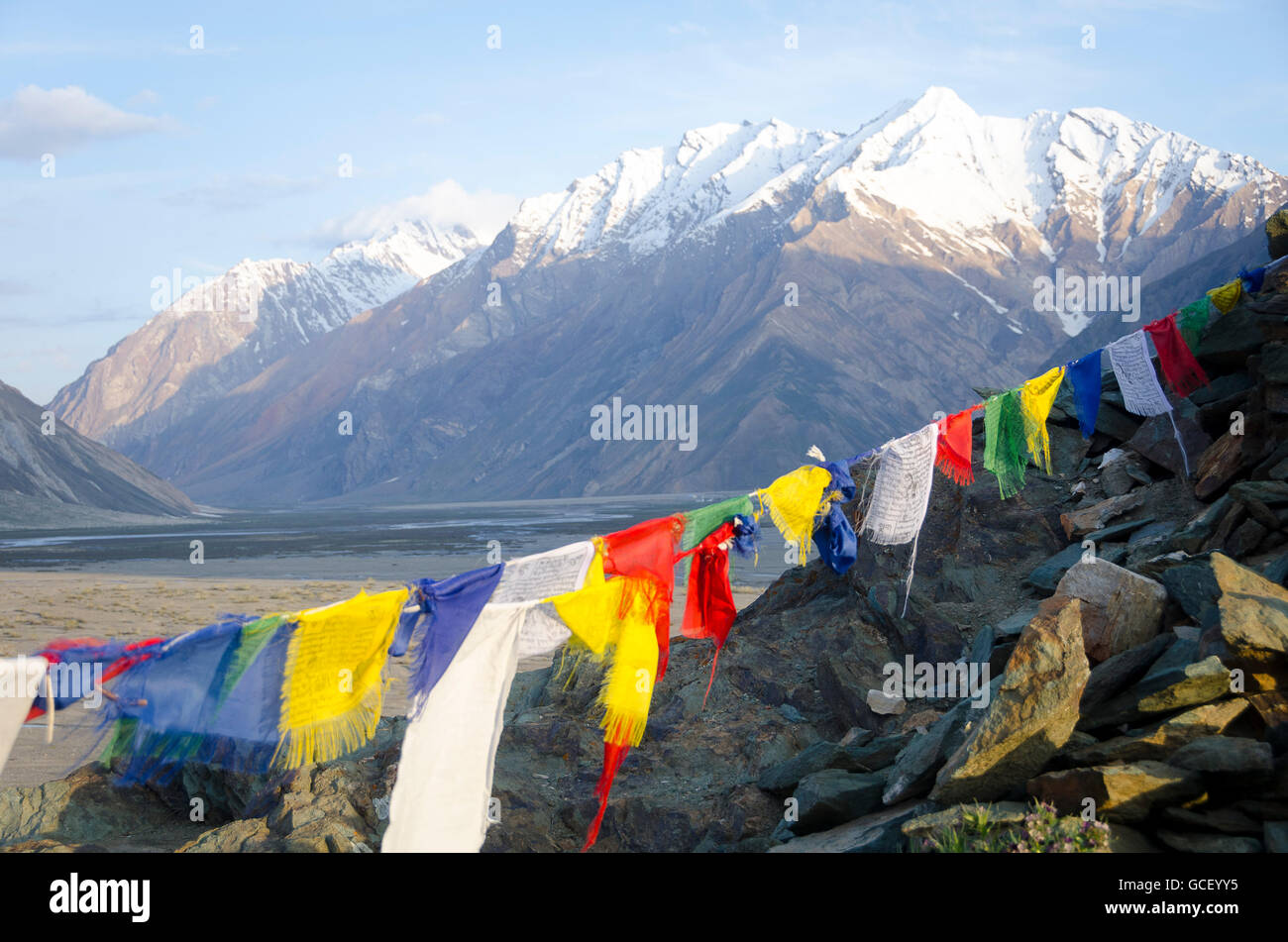 Snowy mountains and prayer flags, Himalayas, Arid mountains and prayer ...