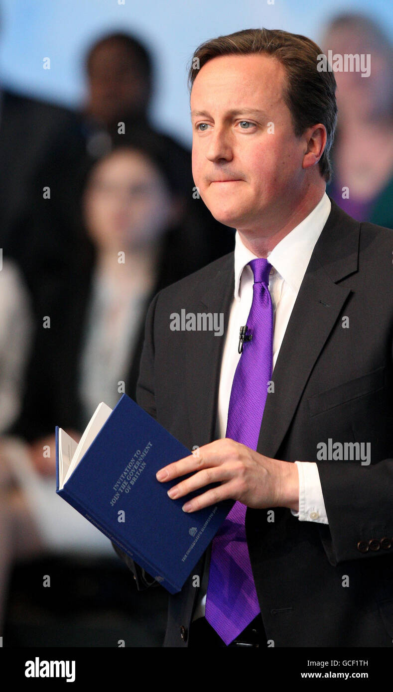Conservative Party leader David Cameron reads a copy of the party's ...