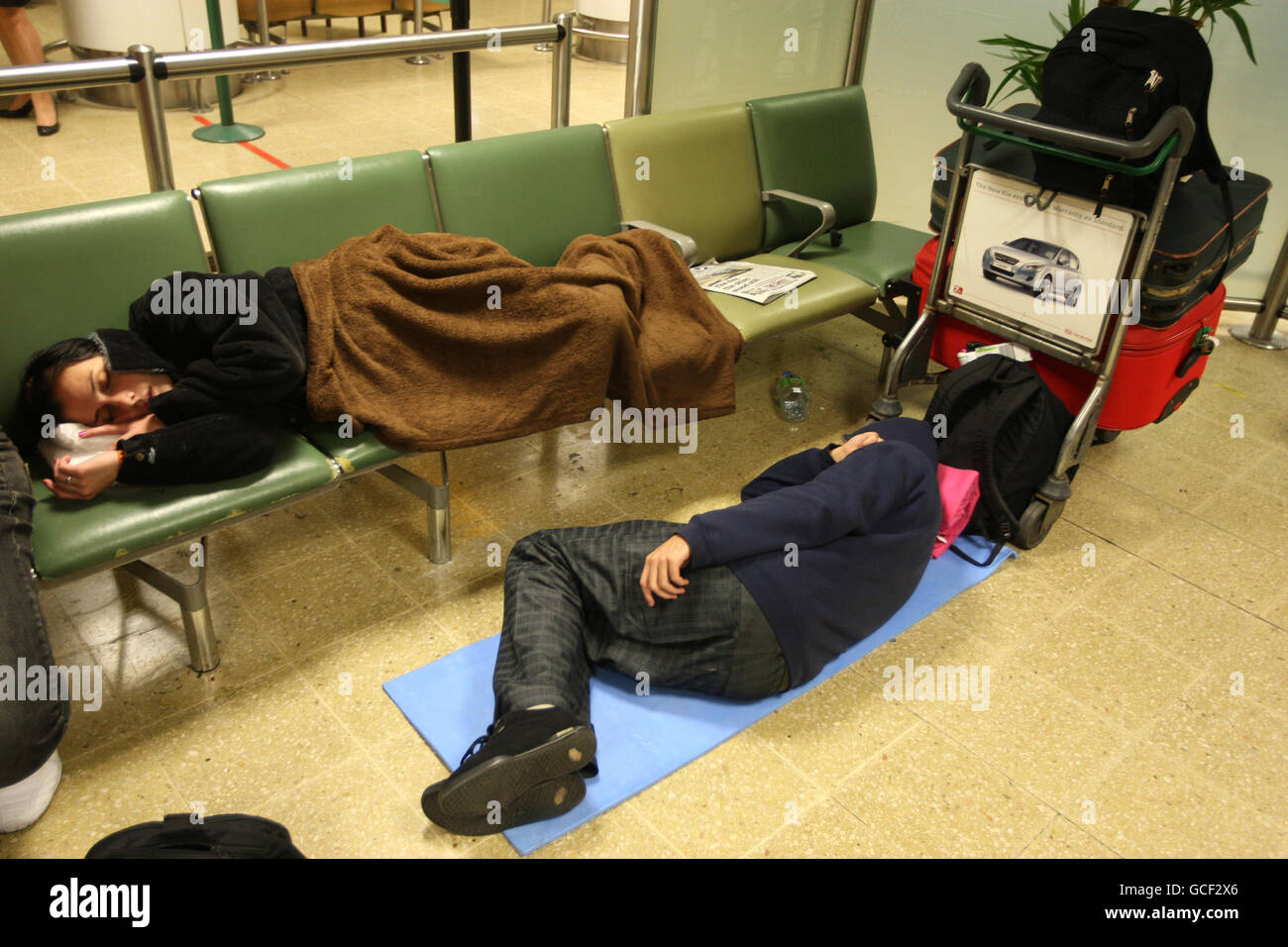 Passengers sleep in Terminal 1 of Heathrow Airport in Middlesex which ...