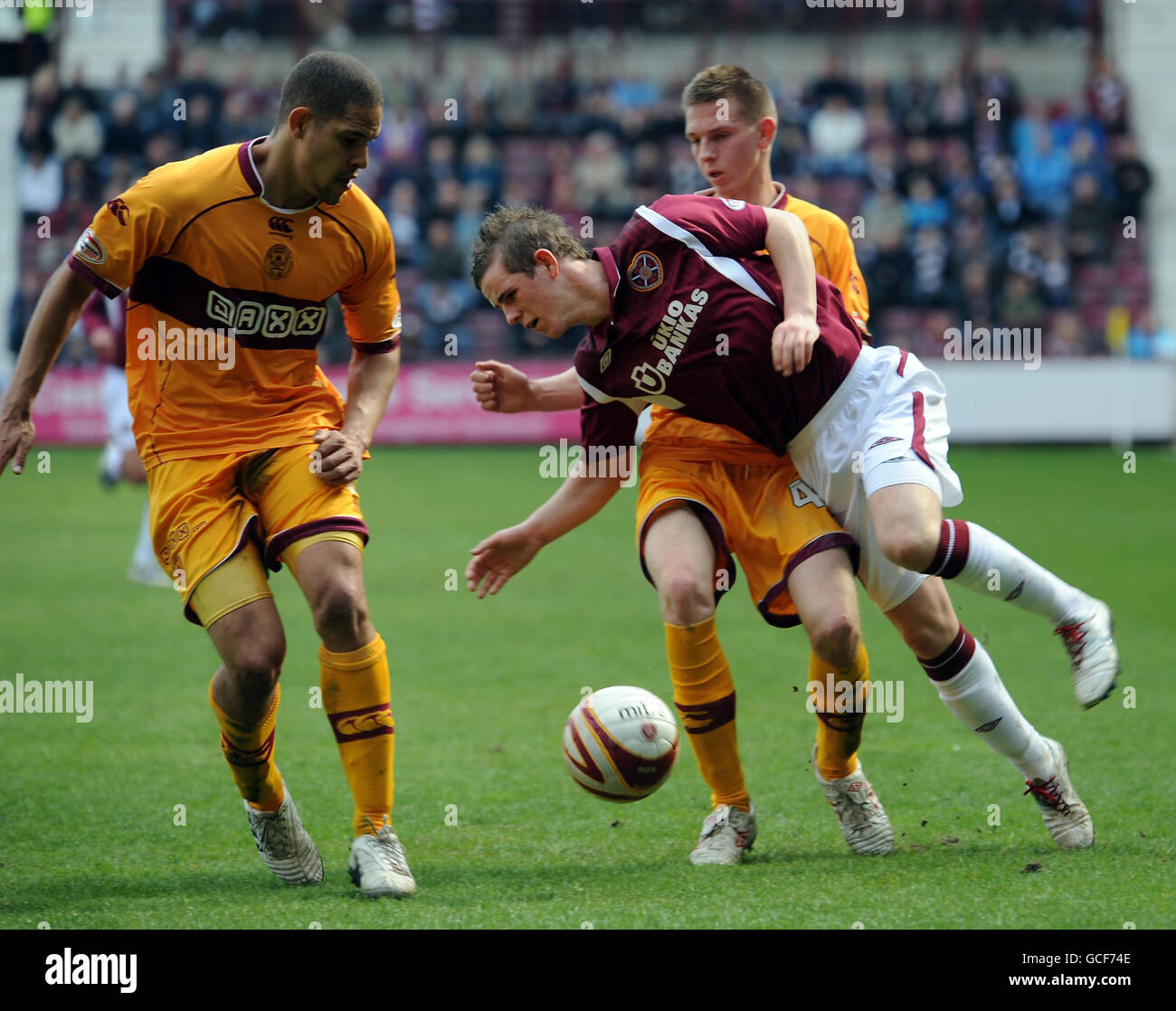 Motherwells Giles Coke and Steven Saunders tussle with Hearts David ...