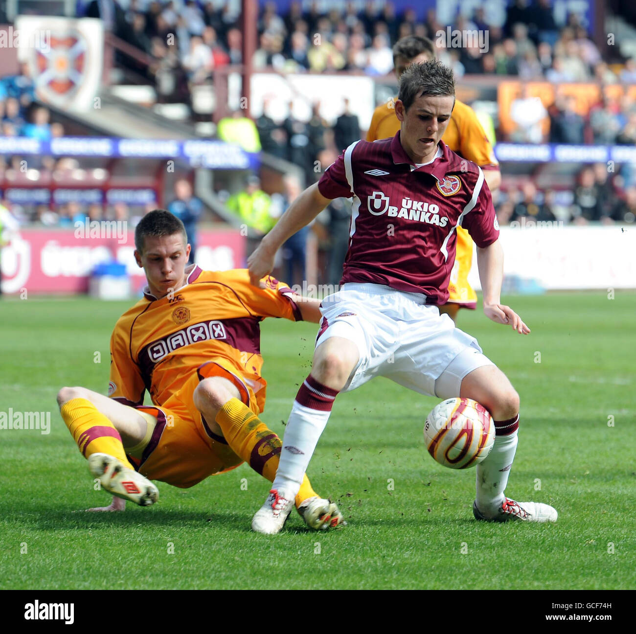 Motherwells Steven Saunders tackles Hearts David Templeton during the ...