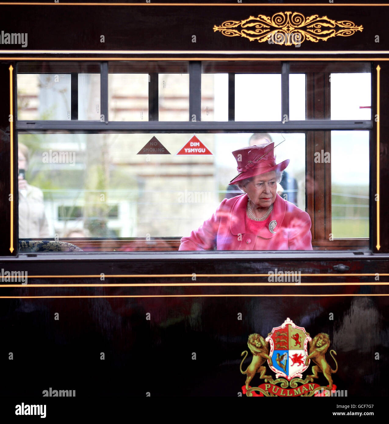 Queen Elizabeth II sits in the carriage of a steam train after boarding ...