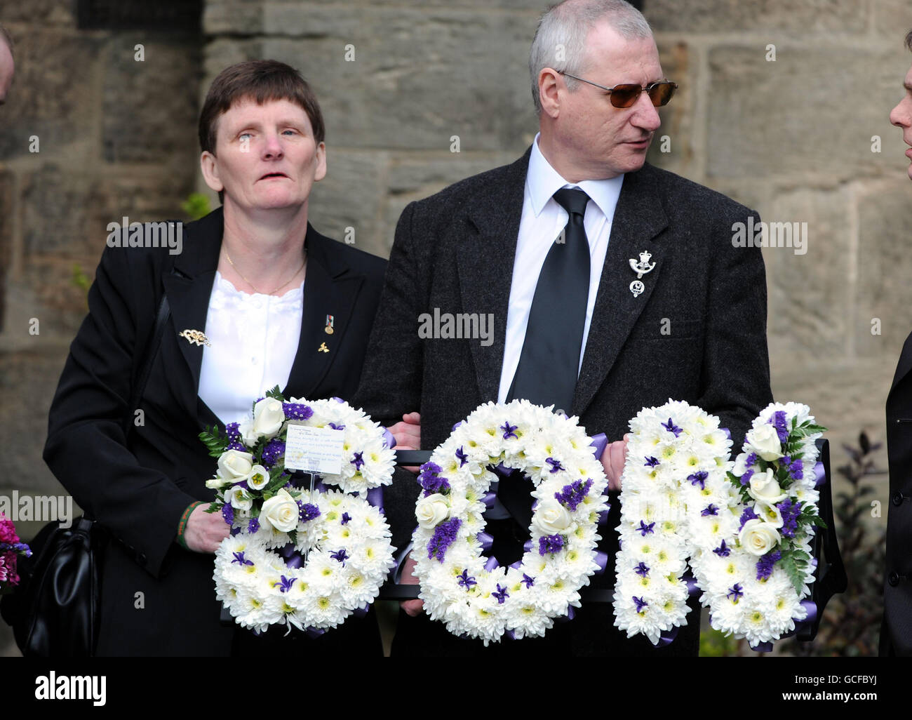 Mother Linda and Father Steven Cockburn watch as the coffin of son ...