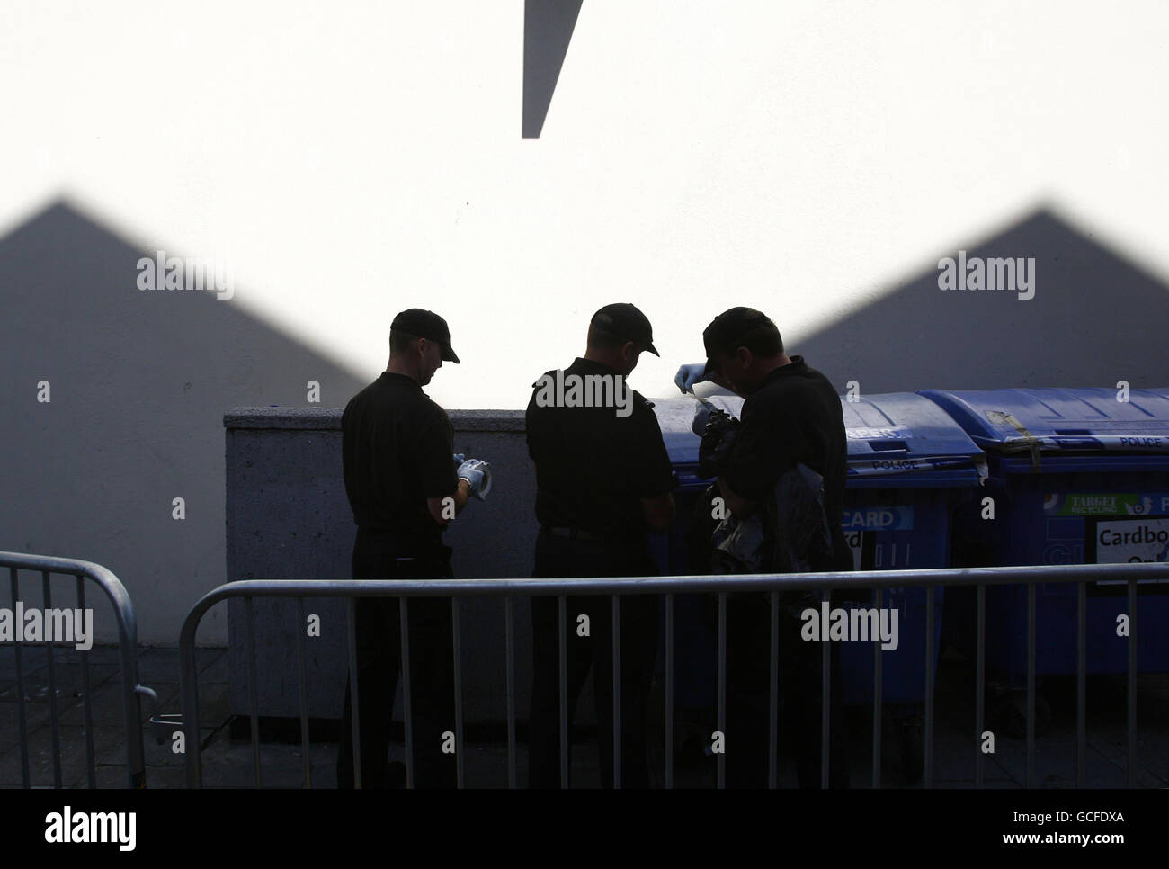 Police officers seal off recycling bins close to the studios of Sky ...