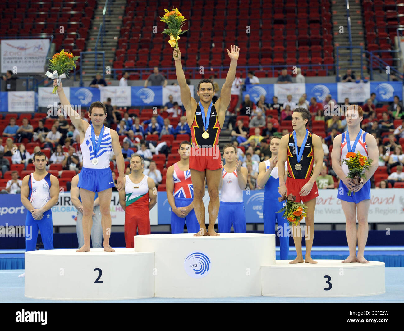 Germany's Matthias Fahrig (centre) celebrates winning gold on the floor ...