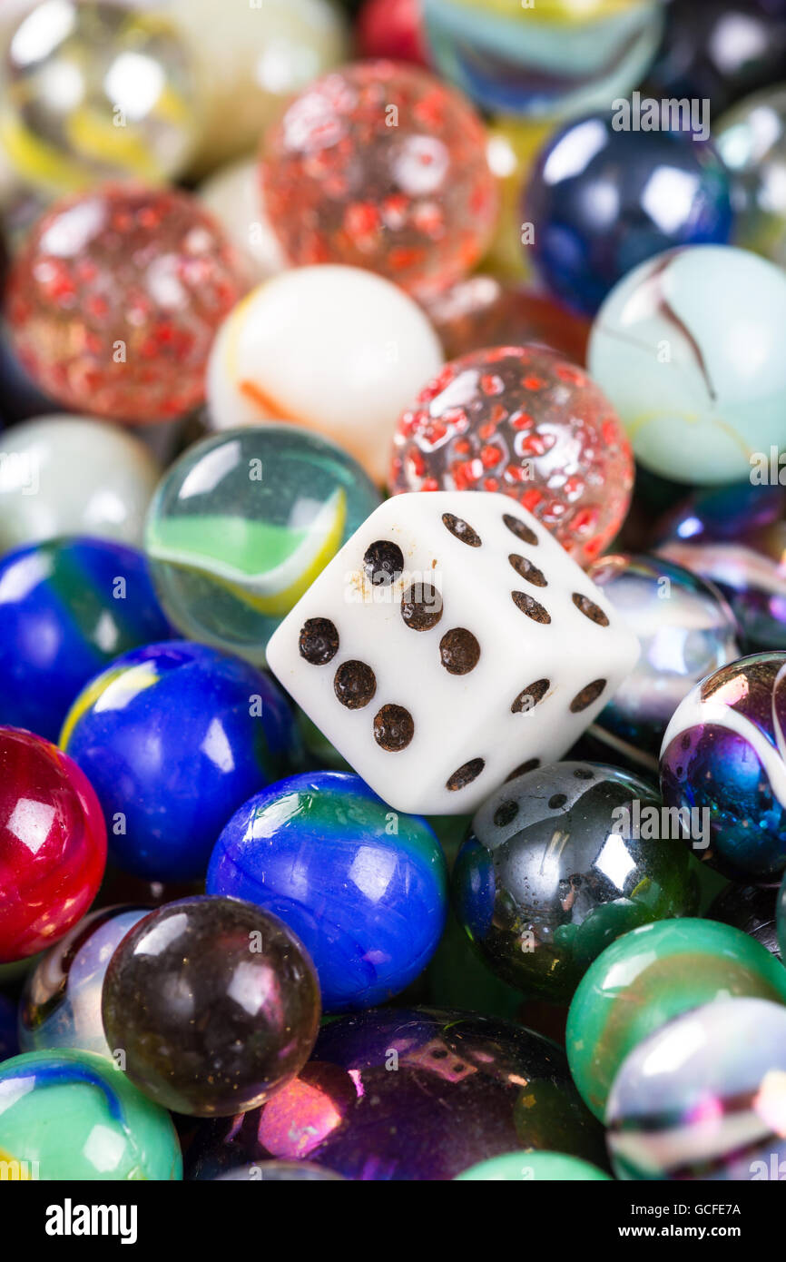 close up of a bunch of marbles in different colors for a background or ...