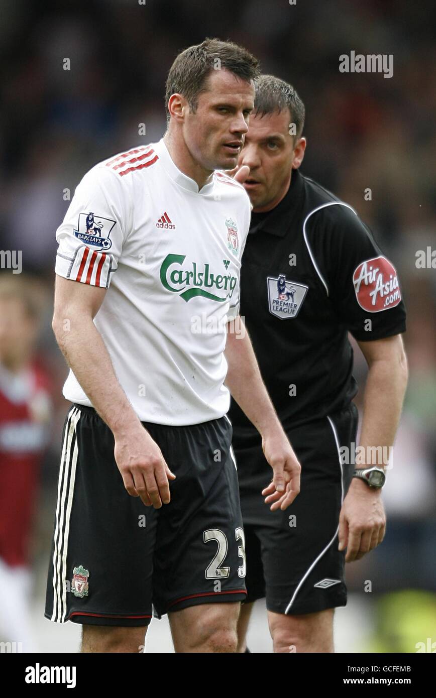 Liverpool's Jamie Carragher (left) and referee Phil Dowd (right) have ...