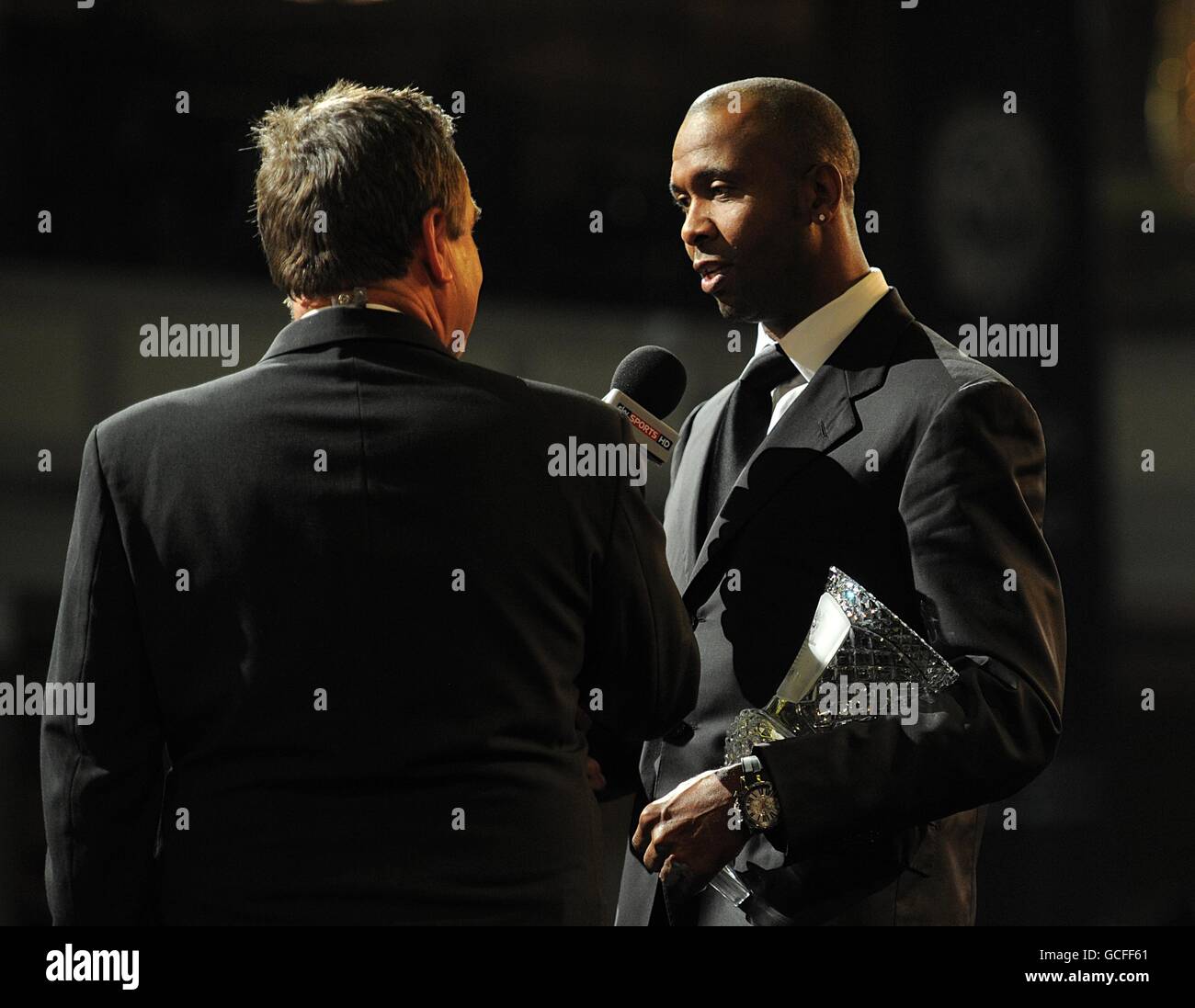 Lucas Radebe (right) collects his Special Merit Award award on stage ...