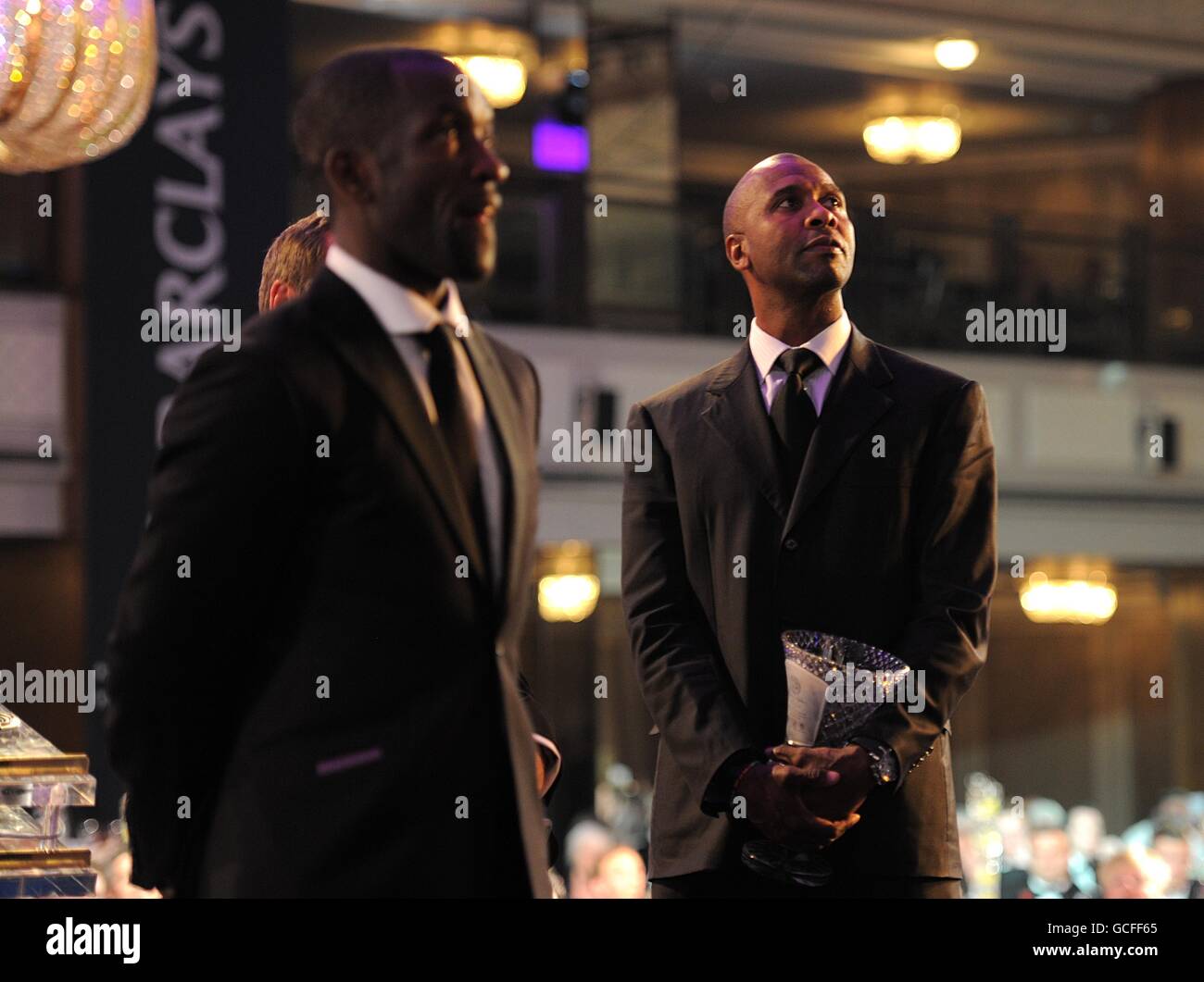 Lucas Radebe (right) collects his Special Merit Award award on stage ...