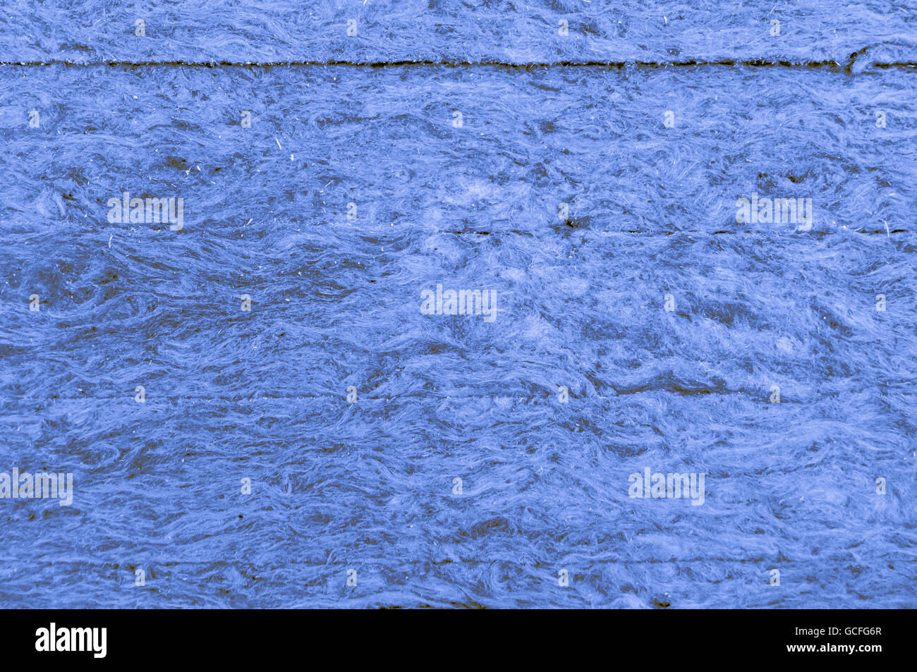 blue yellowish brownish indigo glass padding, glass wool close-up ...