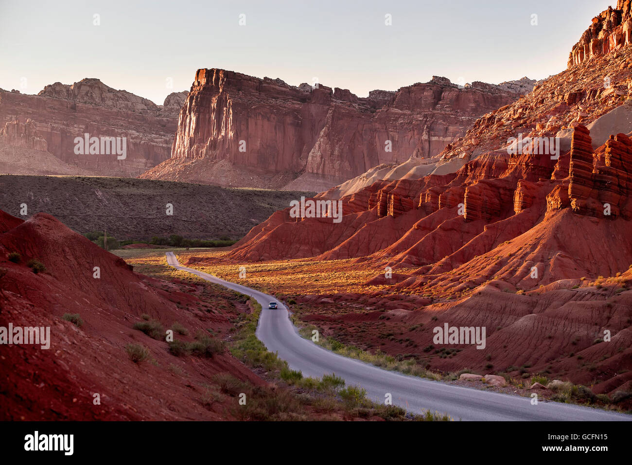 Remote Roadway With One Car Winding Through Canyon Rocks In Southern ...