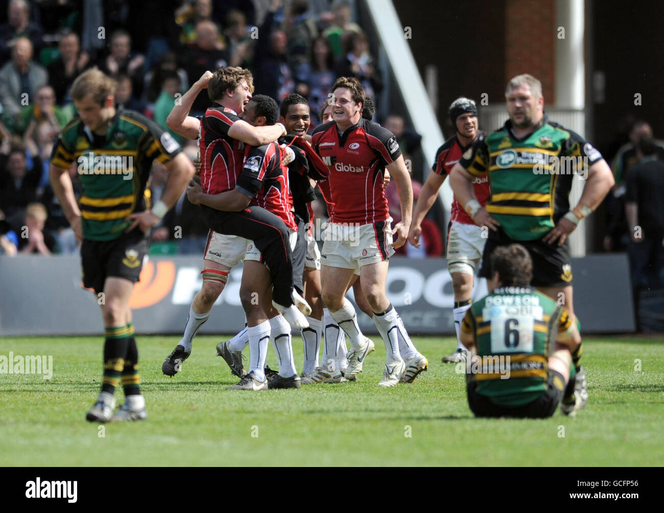 Northampton players stand dejected as the Saracens players celebrate on ...