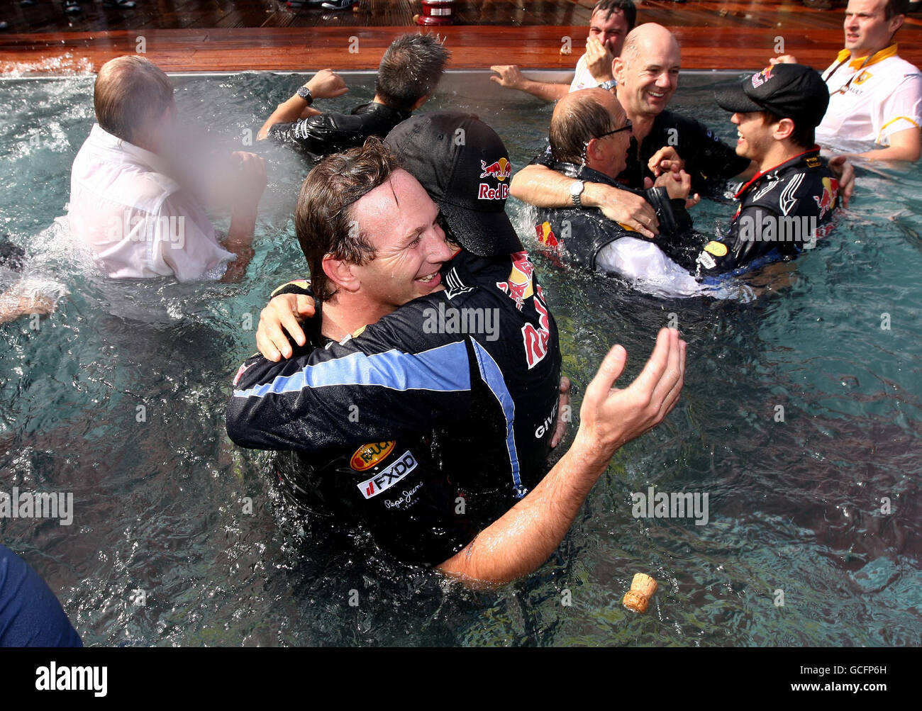 Red Bull team principle Christain Horner (front left) hugs Mark Webber ...