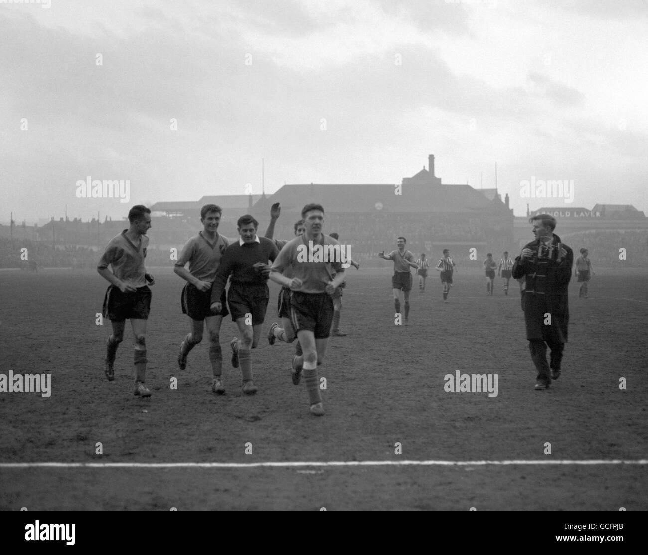 Team-mates escort Norwich City goalkeeper Ken Nethercott as, with his ...