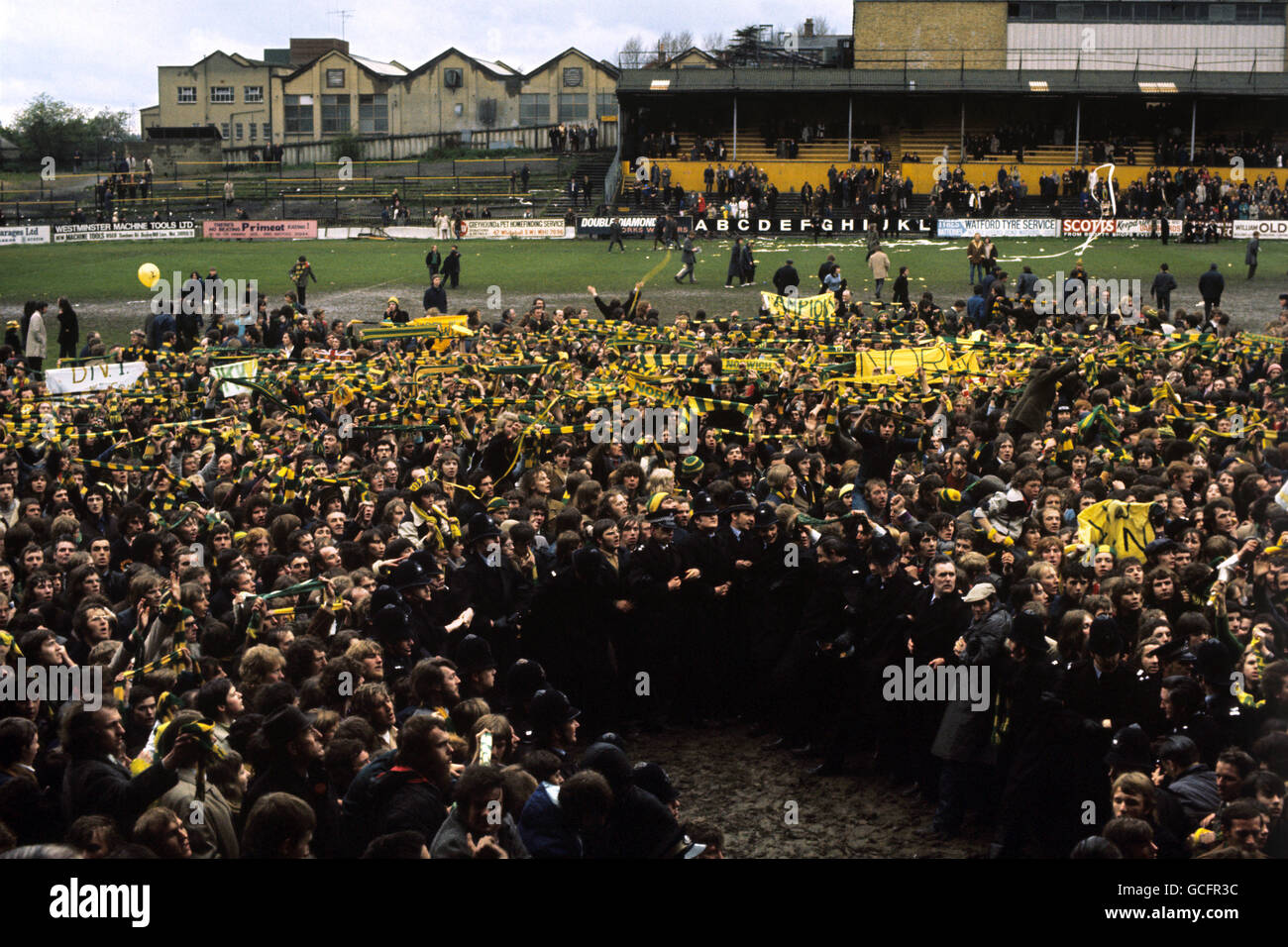 Norwich City fans invade the Vicarage Road pitch after seeing their ...