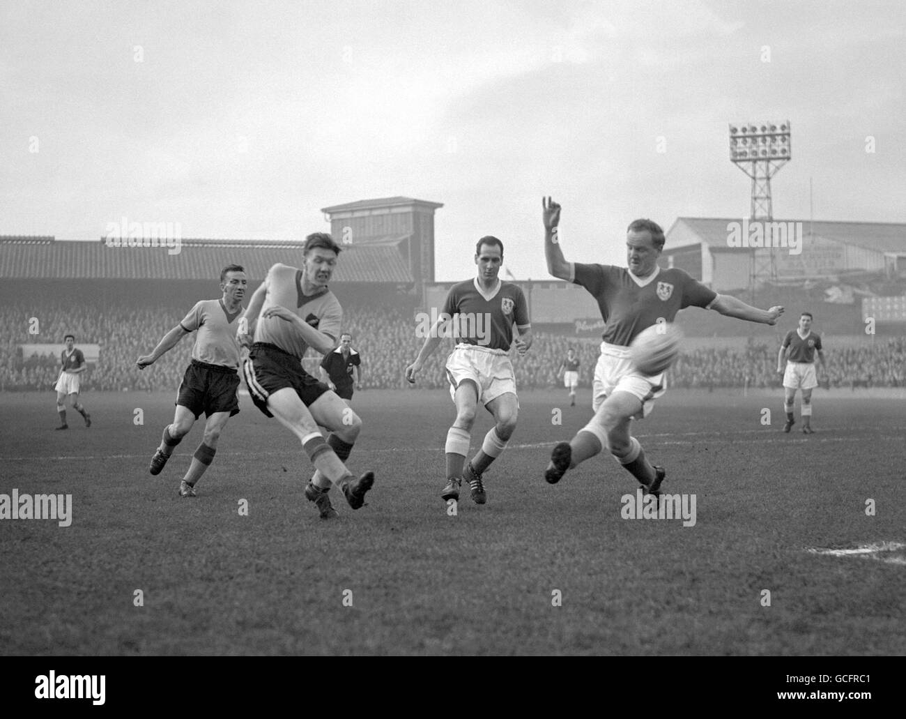 Matt Crowe, Norwich City (left) gets a shot off as he's intercepted by ...