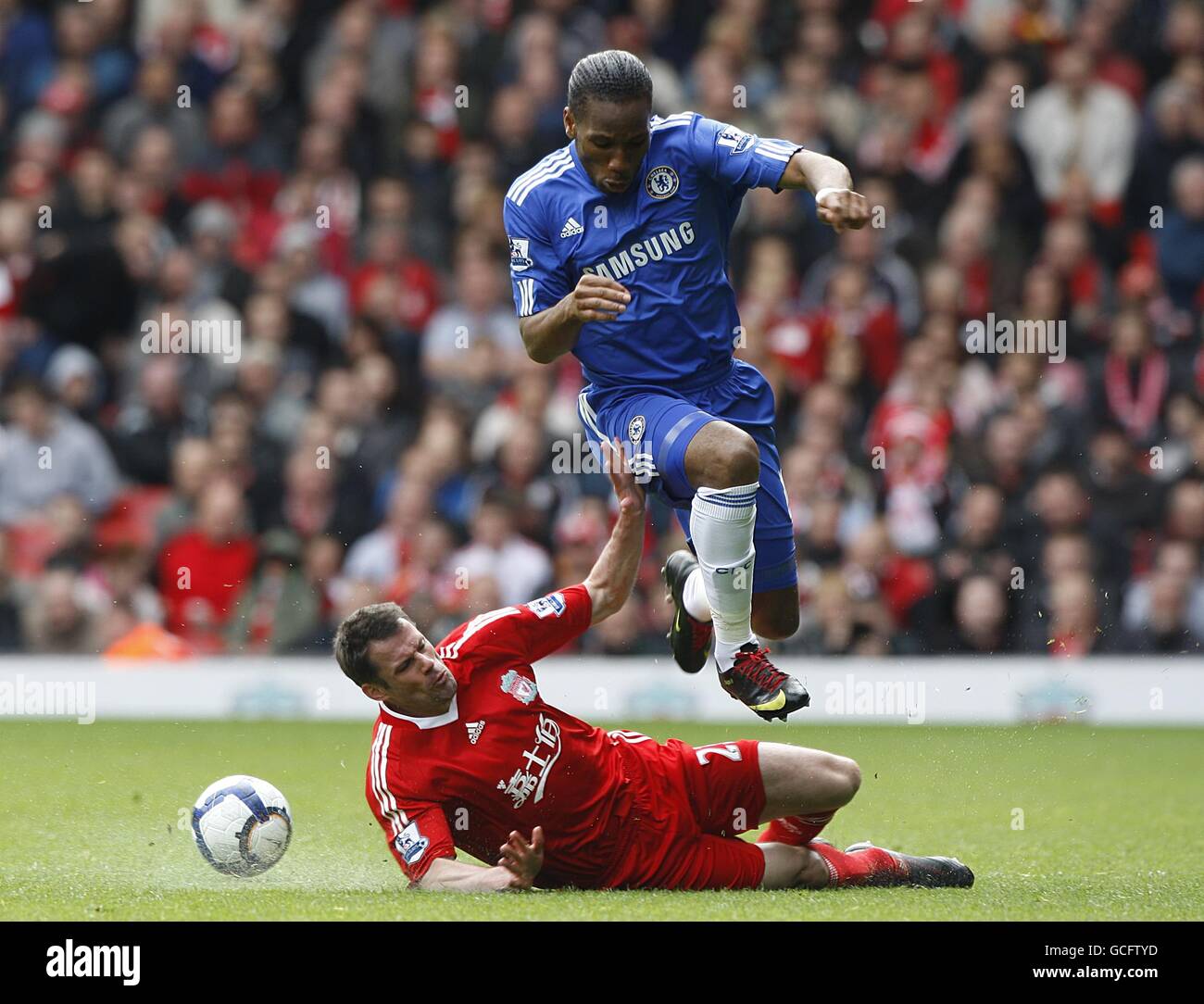 Liverpool's Jamie Carragher (left) challenges Chelsea's Didier Drogba ...