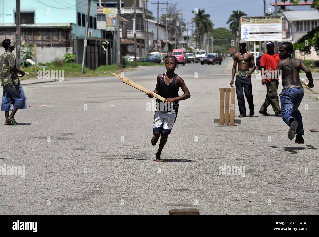 A young boy bats in a street cricket match in Georgetown, Guyana Stock ...
