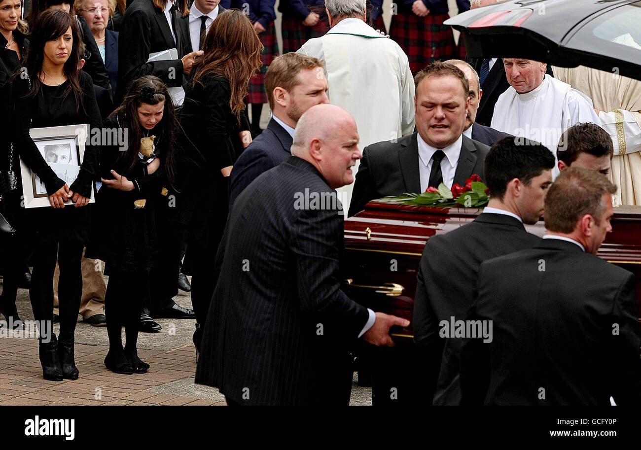 Gerry Ryan's coffin, is placed into the hearse, watched by his daughter ...