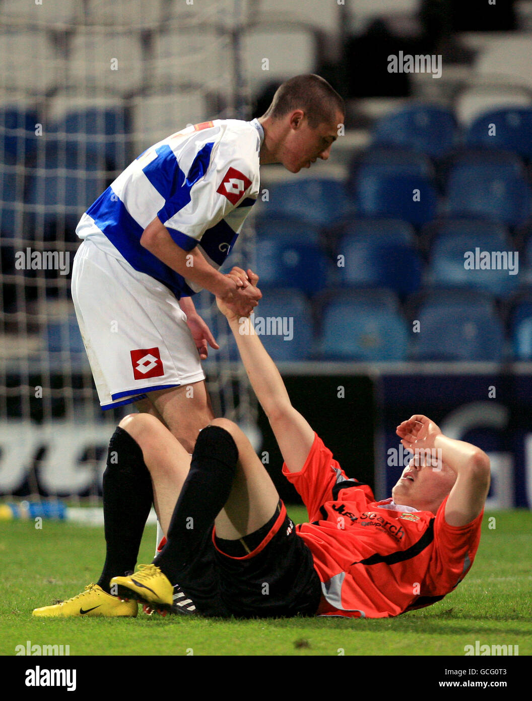 Queens Park Rangers' Michael Harriman (left) helps Stockport County's ...