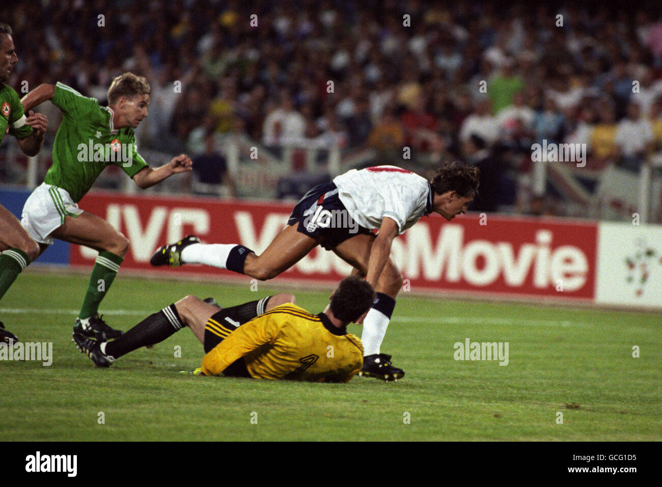 England's Gary Lineker stumbles over Ireland goalkeeper Pat Bonner as ...