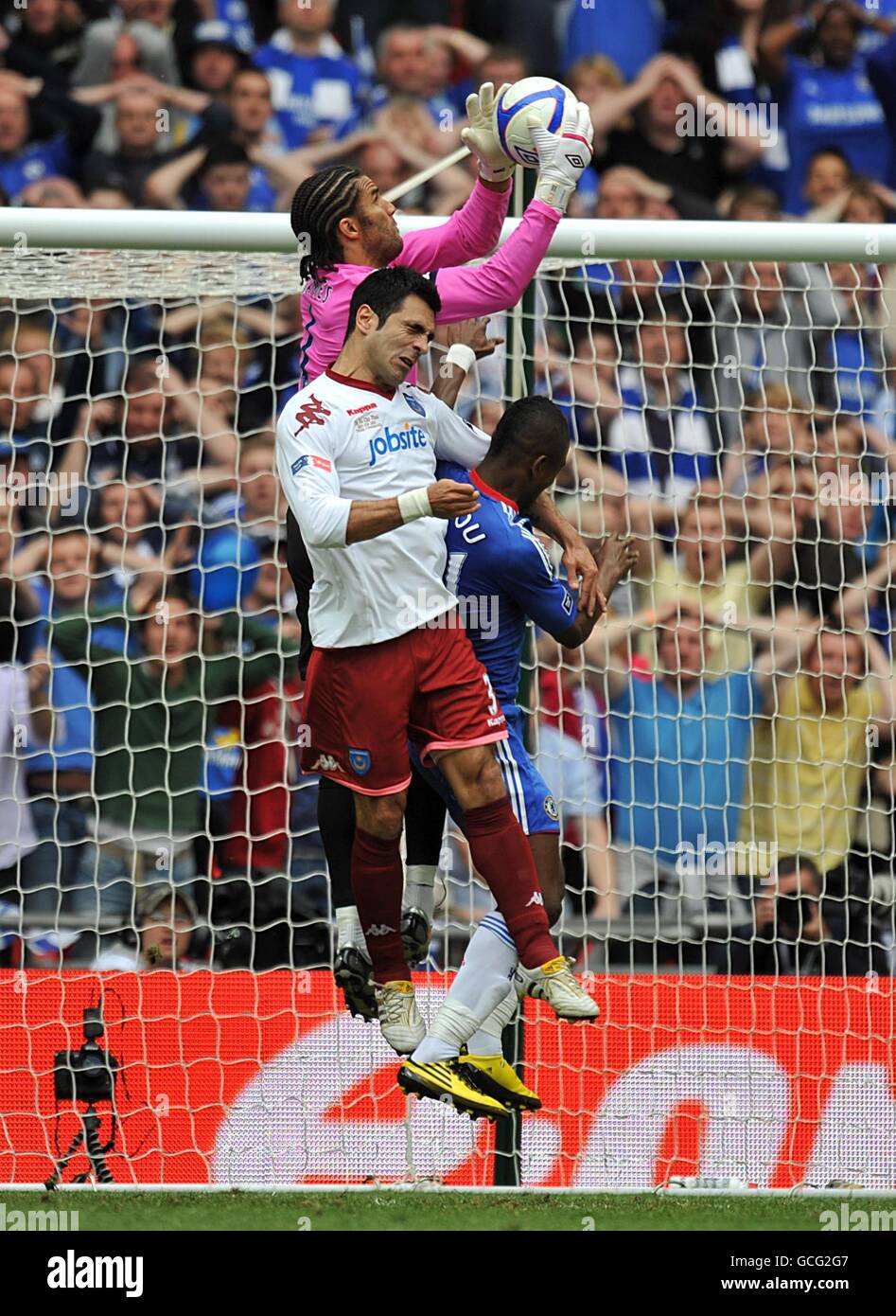 Portsmouth goalkeeper David James (top) jumps highest to claim the ball ...