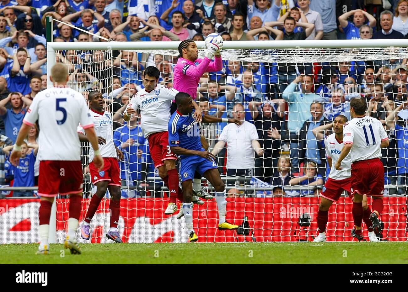 Portsmouth goalkeeper David James (top) catches the ball above the head ...