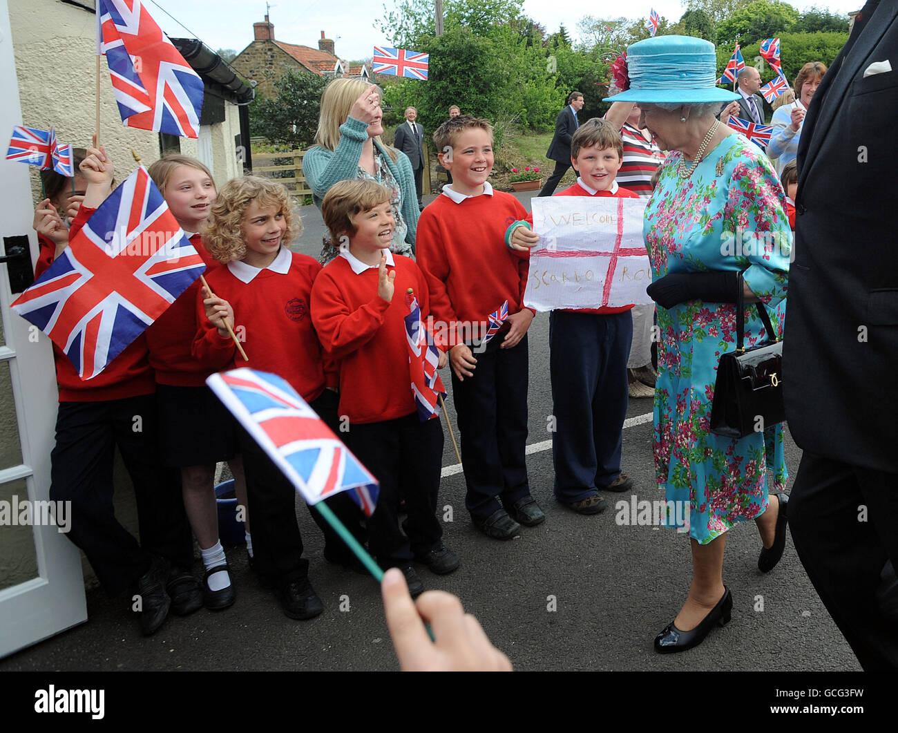 Queen Elizabeth II is greeted by school children from Hackness Church ...