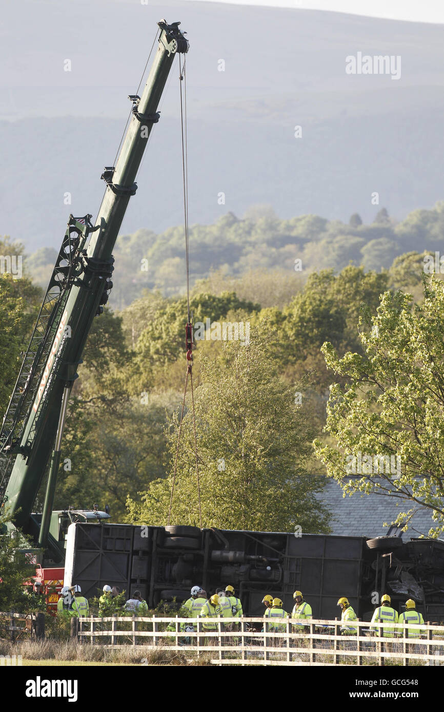 A crane prepares to lift a coach at the scene on the A66 near Keswick ...