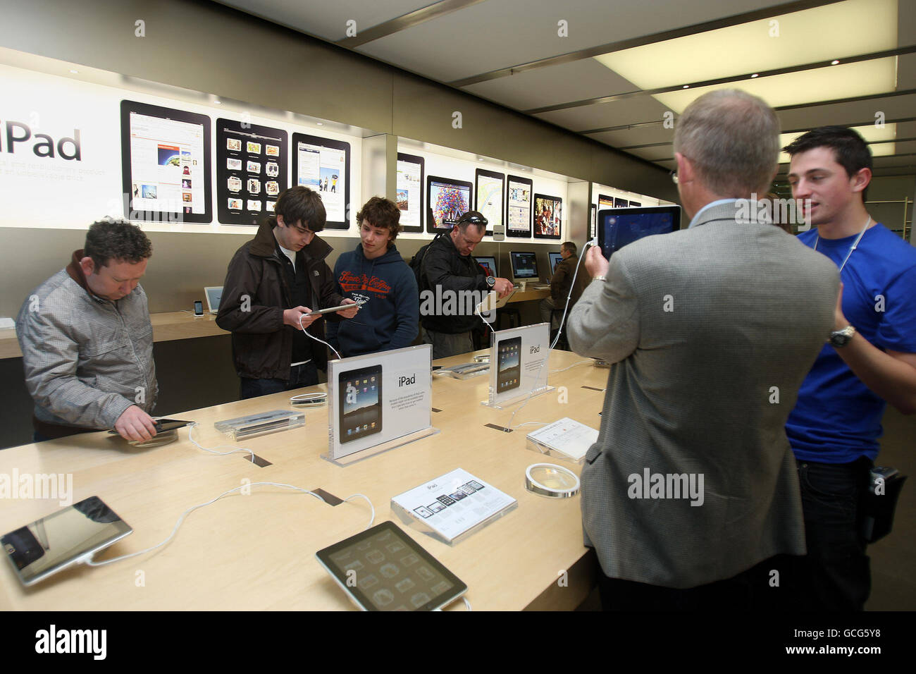 Customers try the new Apple iPad at the Apple shop in the Victoria ...