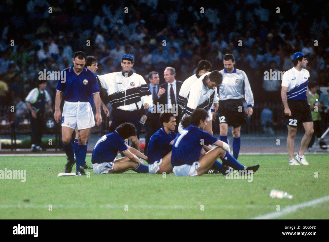 Italy's dejected players sitting the turf following their elimination ...