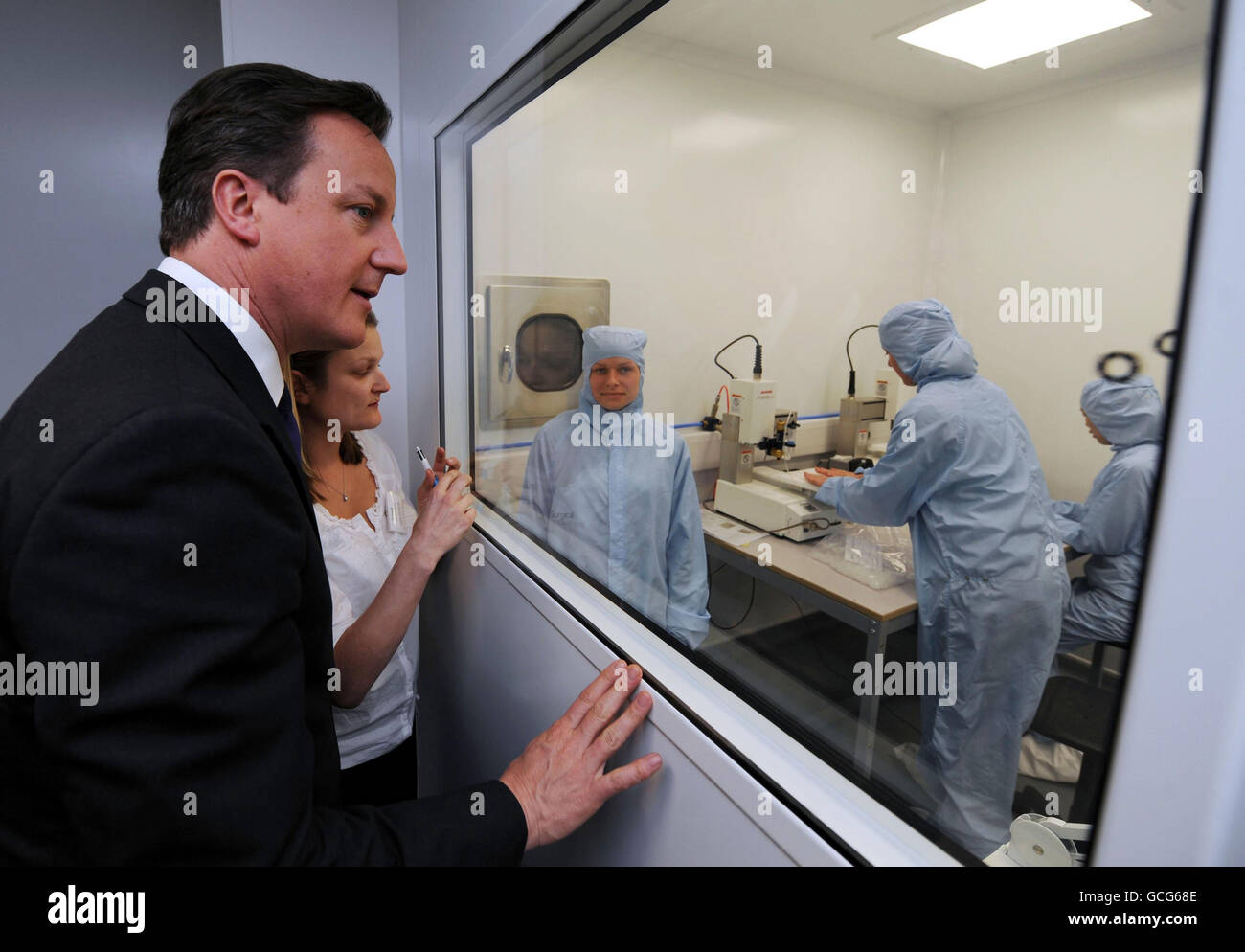 Prime Minister David Cameron looks through a window into the clean room ...