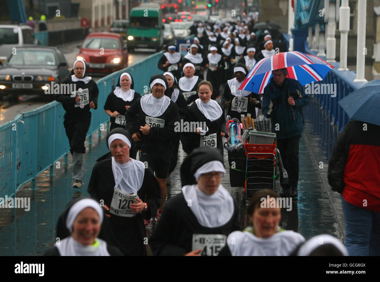 Men and women dressed as nuns run across Tower Bridge in London, as ...