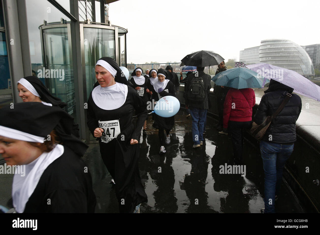 Men and women dressed as nuns run across Tower Bridge in London, as ...