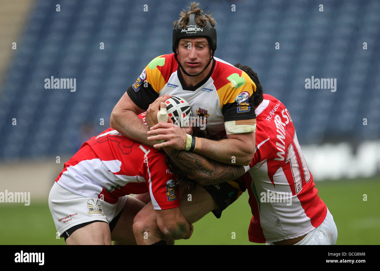 Bradford Bull's Elliott Whitehead (centre) and Crusaders RL's Frank ...