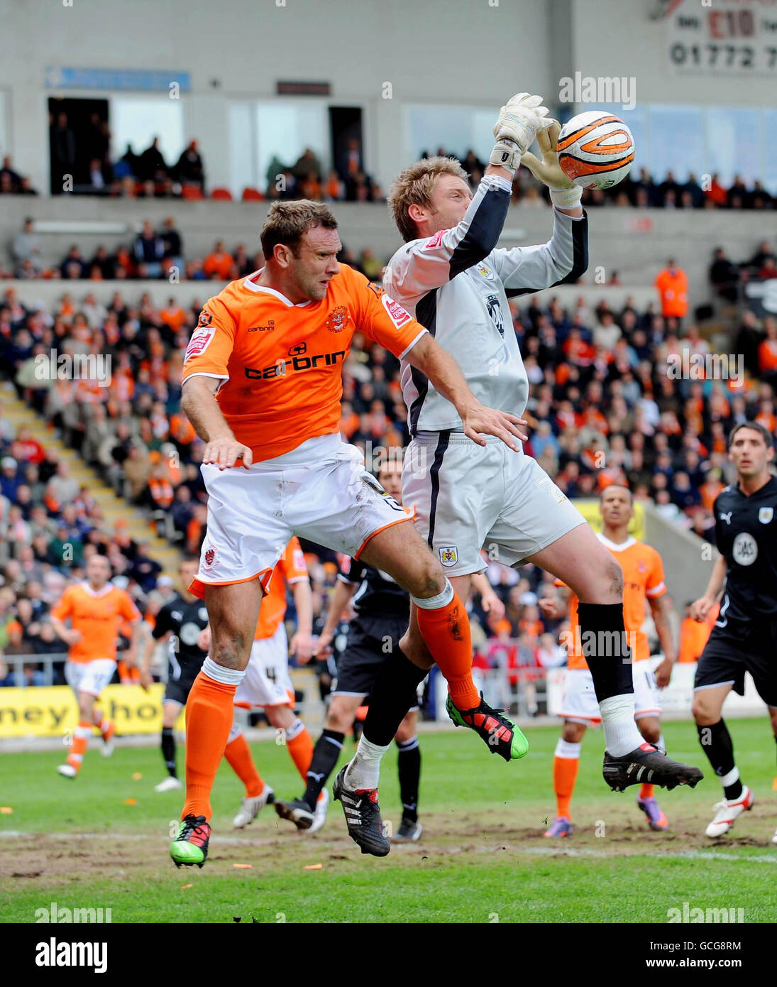 Blackpool's Ian Evatt (left) is beaten to the ball by Bristol City ...