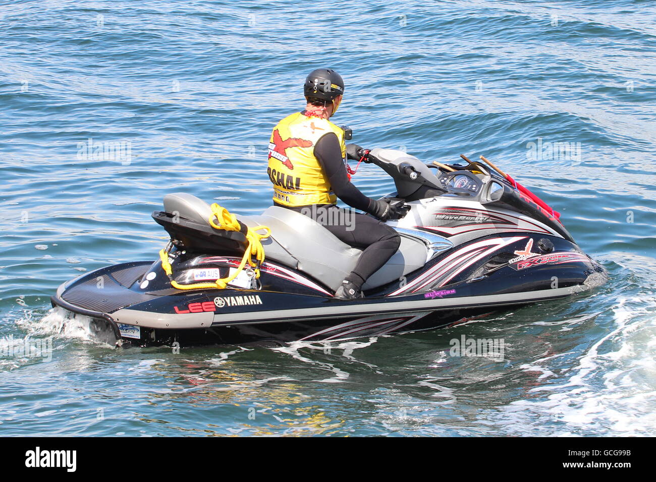 A race marshall, driving a Yamaha Waverunner, watches the proceedings ...